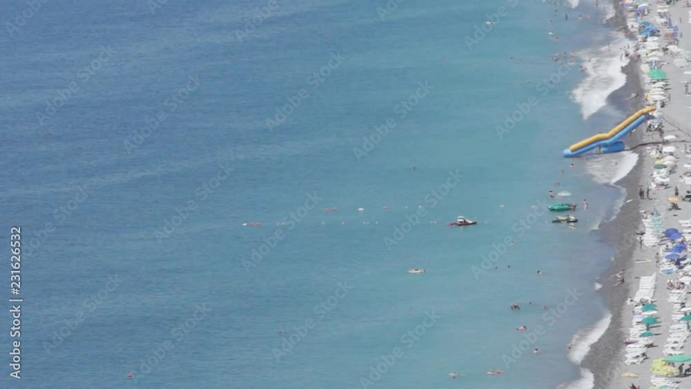 Sea resort coast in the high tourist season. people relax and ...