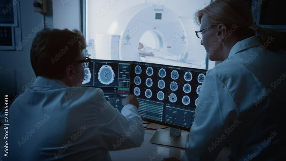 In Control Room Doctor and Radiologist Discuss Diagnosis while Watching ...