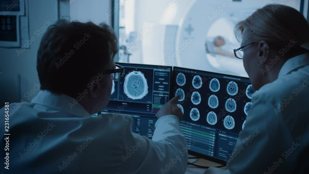 In Control Room Doctor and Radiologist Discuss Diagnosis while Watching ...