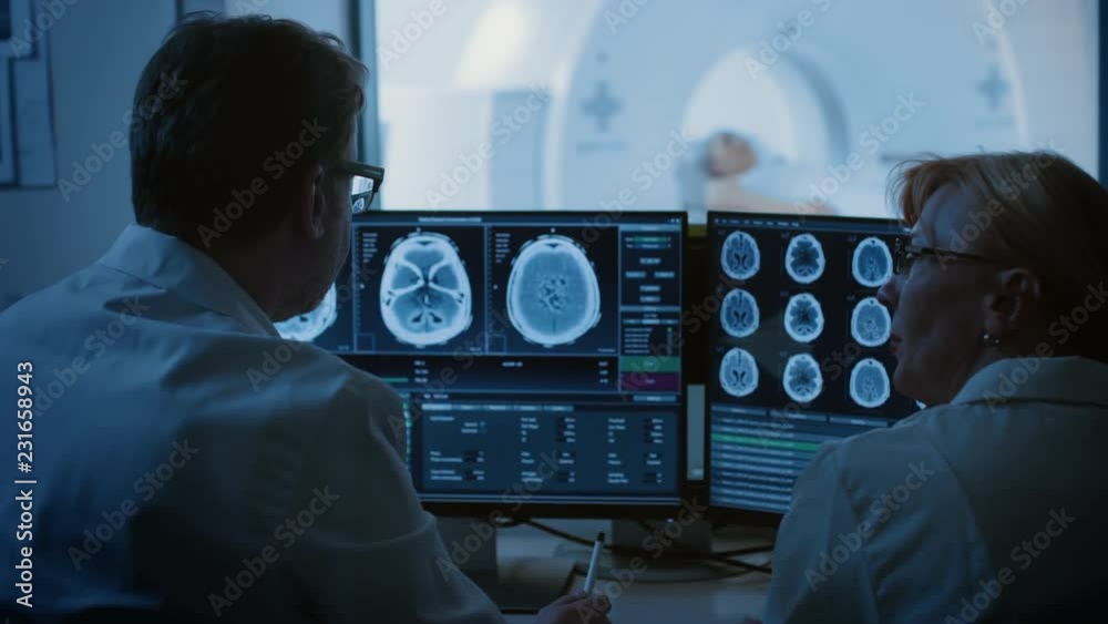 In Control Room Doctor and Radiologist Discuss Diagnosis while Watching ...