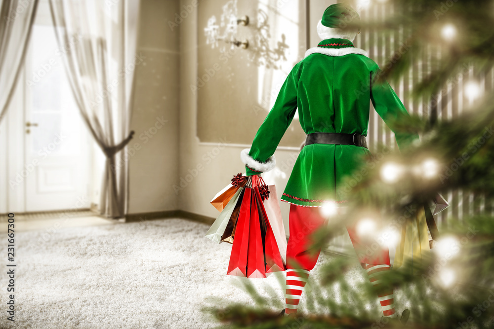 Christmas elf in home interior with big window and christmas tree Stock ...