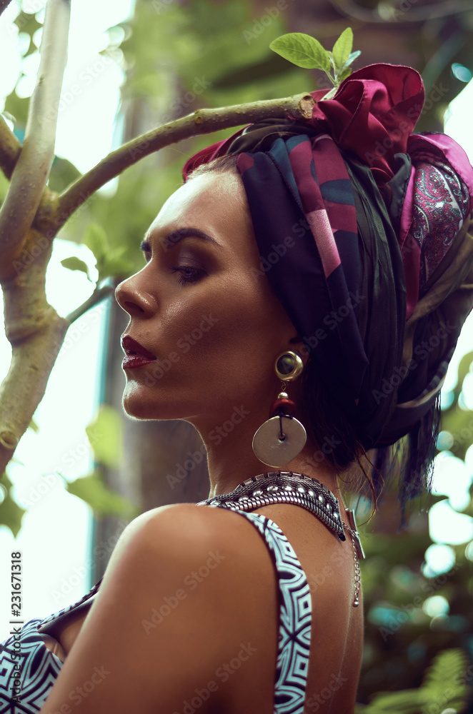 Fashion model in turban posing outdoors with jungle background Stock ...