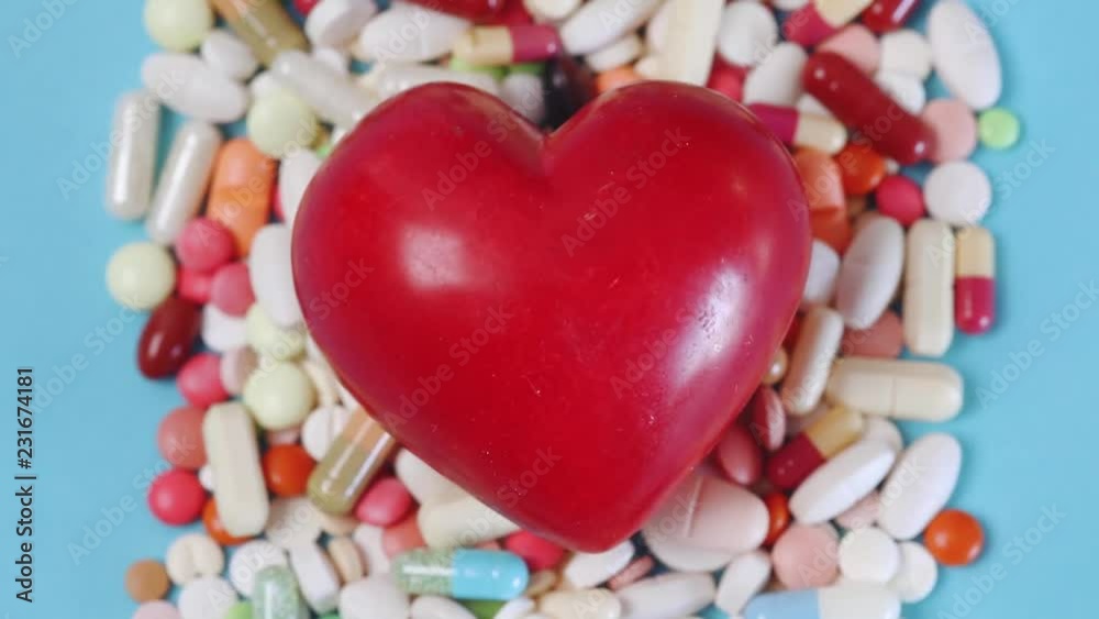 Heart beating rhythmically among medication pills Stock Video | Adobe Stock