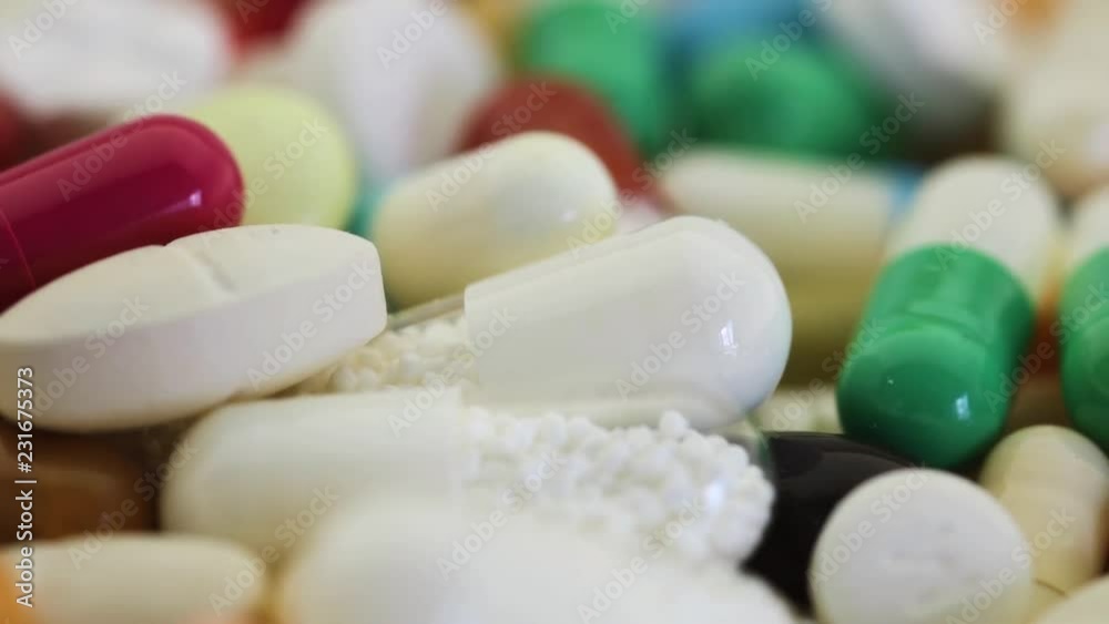 Closeup view of medication pills spinning through view Stock Video ...