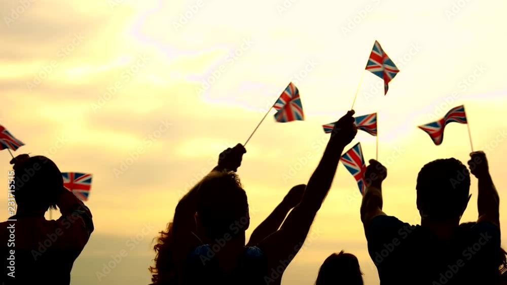People raising British national flags. Patriotic people waving Union ...