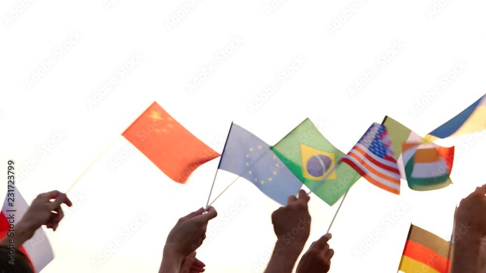Human hands waving International flags. Human hands holding variety of ...