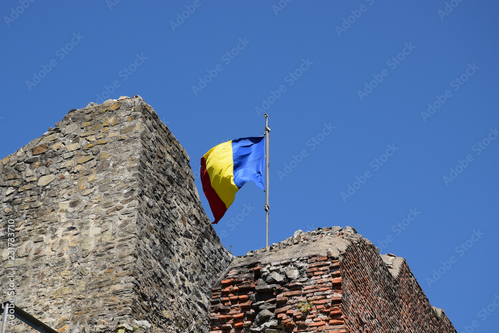 Romanian flag waving in the wind at the ruin of Poenari Castle. Romania ...