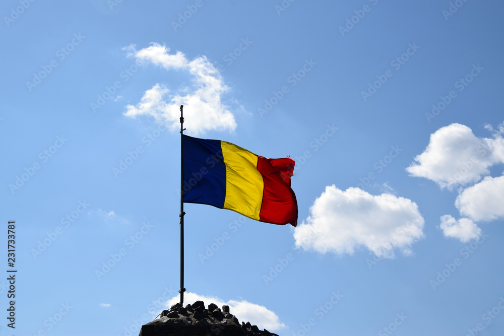 Romanian flag waving in the wind in front of a clean blue sky. Romania ...