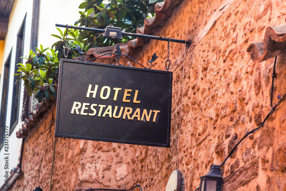 Black sign Hotel and Restaurant in gold letters. Advertising sign for a ...