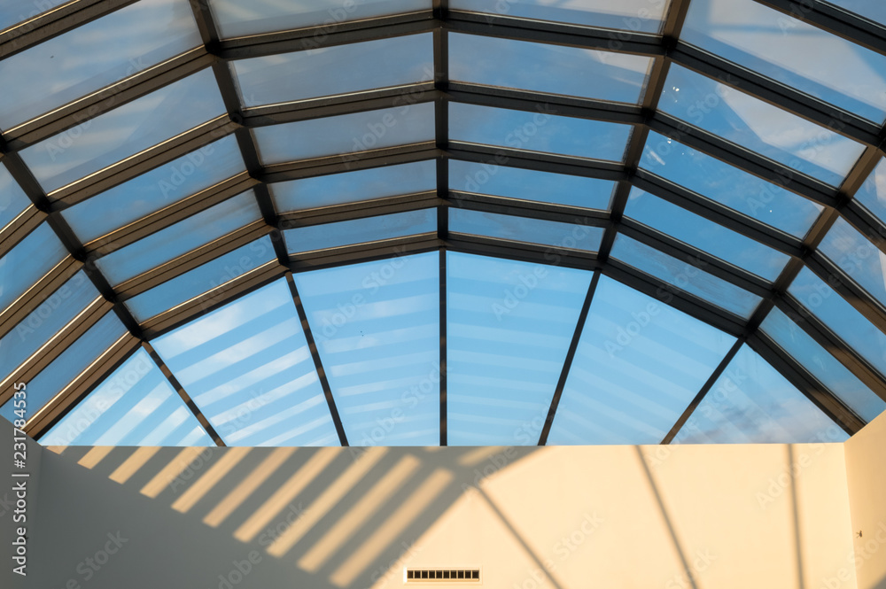 Modern glass roof with steel grid frames. Skylight rooftop window with ...