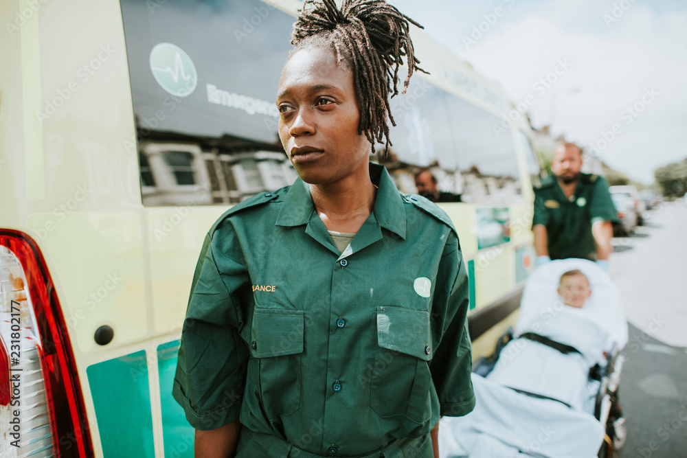 Paramedics rolling a young patient on an ambulance stretcher Stock ...