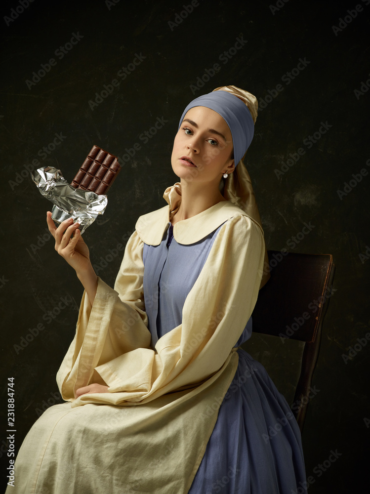 Medieval woman in historical costume wearing corset dress and bonnet ...