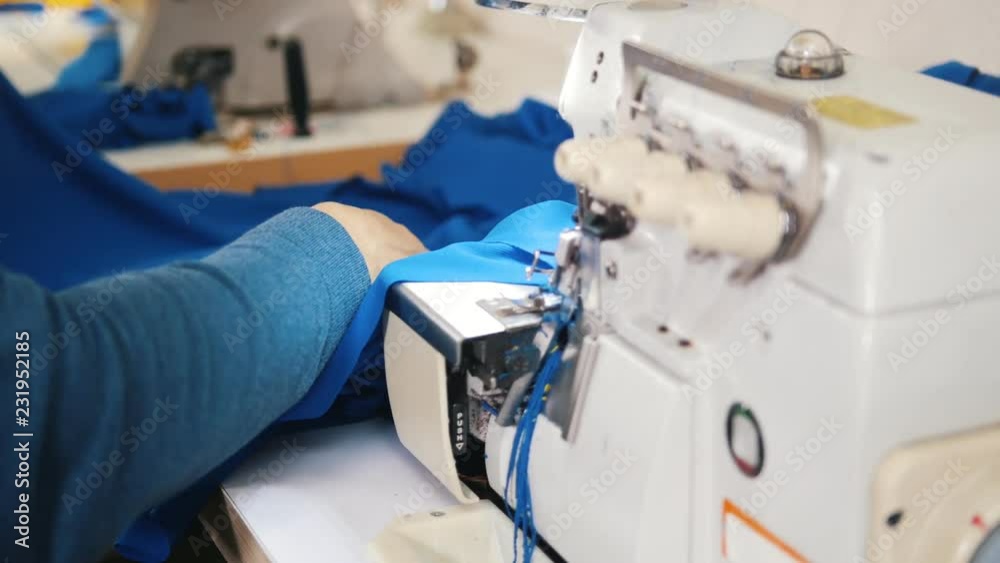 Making clothes. Woman works with cloth on Sewing Machine. Focus on ...
