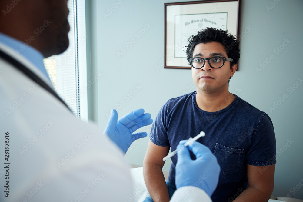 Doctor about to give injection to patient Stock Photo | Adobe Stock