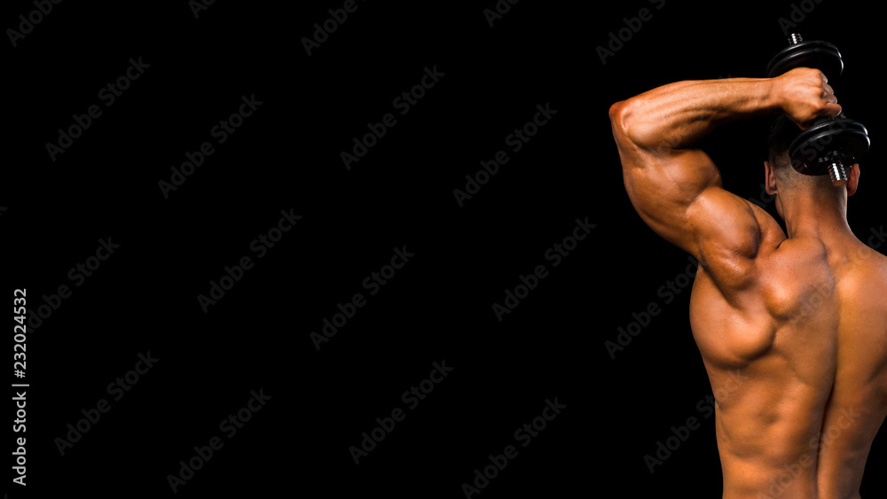 Muscular athletic bodybuilder fitness model pumping triceps on dark ...