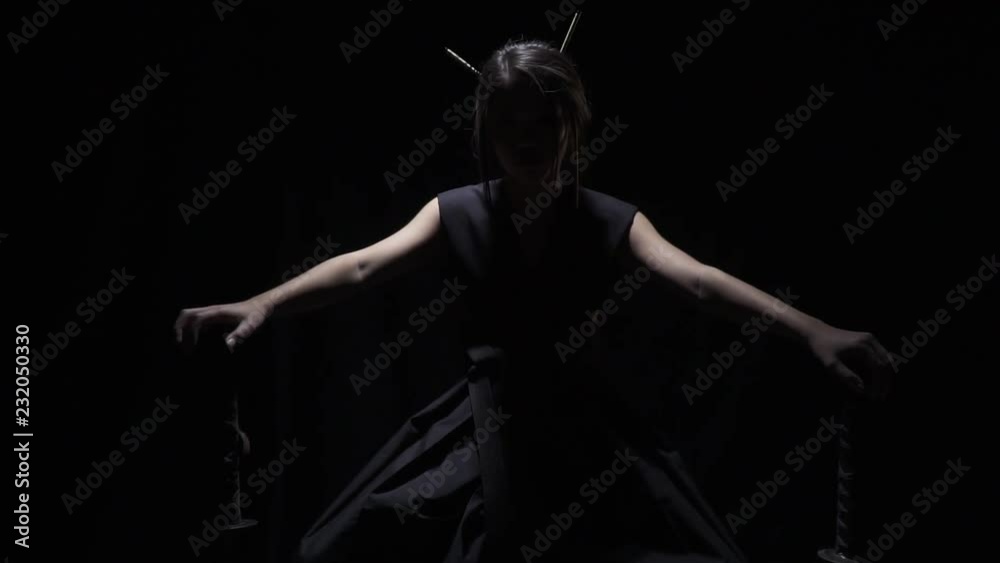 Samurai queen in the dark, holding two katanas Stock Video | Adobe Stock