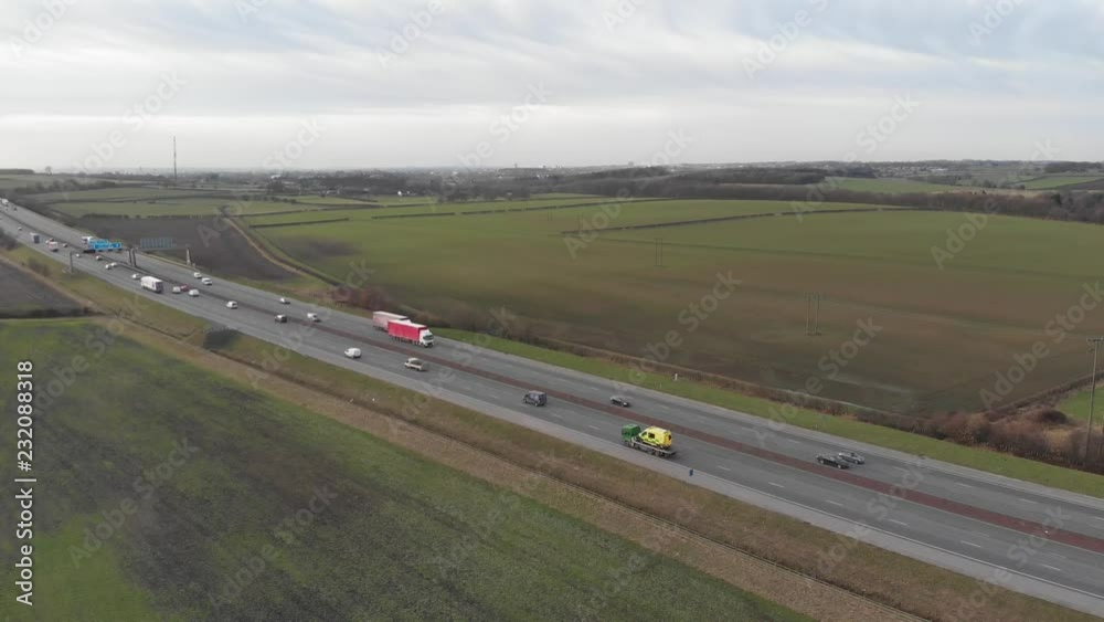 Aerial 4k footage of a Motorway highway in the UK, showing cars, vans ...