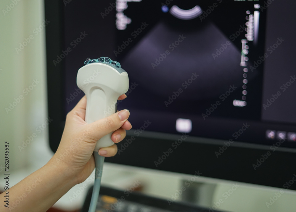 Ultrasonography (USG) hand holding ultrasound probe and coupling gel ...