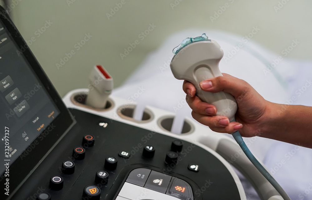 Ultrasonography (USG) hand holding ultrasound probe and coupling gel ...