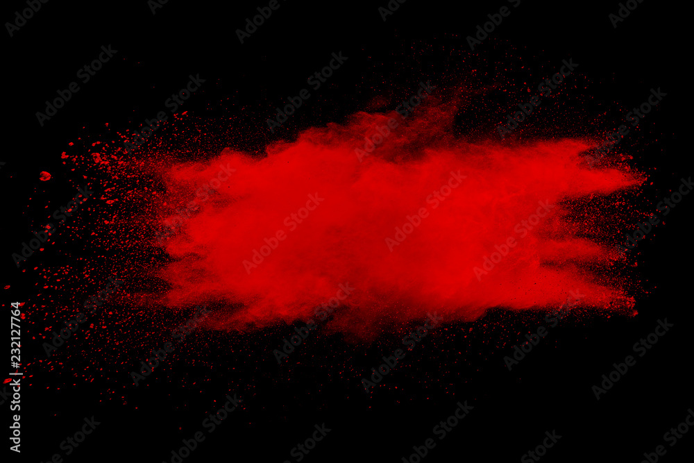 Red color powder explosion on black background.Freeze motion of red ...