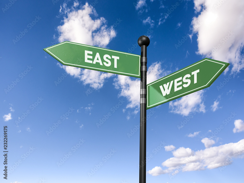 arrow road signs of words east and west on the blue sky. 3D ...