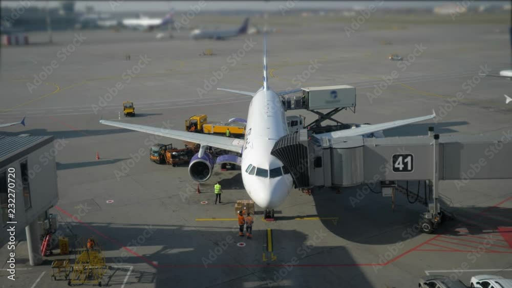 Aircraft which stands near airport terminal. The plane stands at the ...