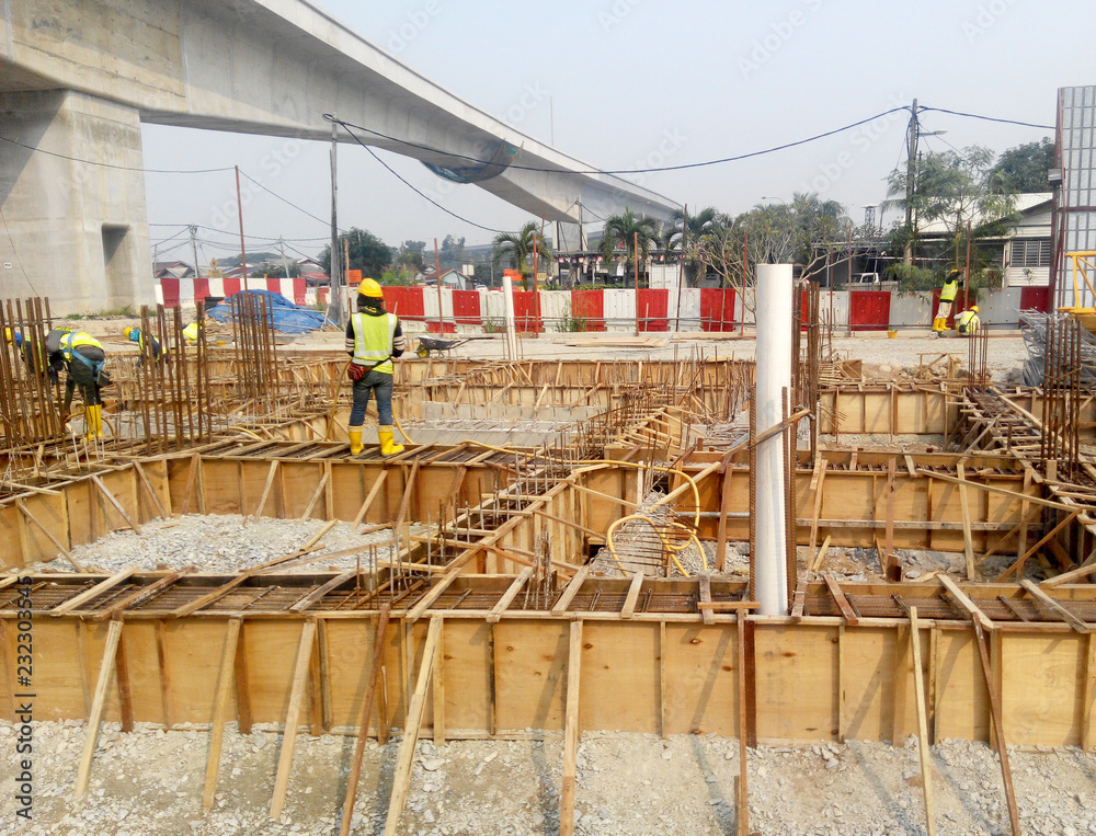 Ground beam form work constructed by workers at the construction site ...