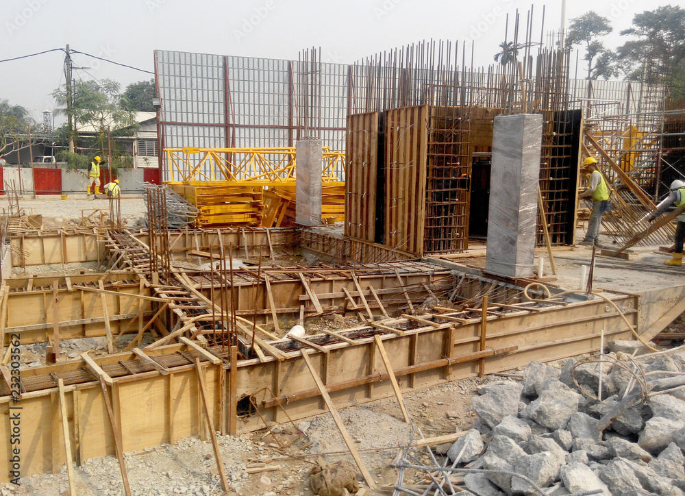 Ground beam form work constructed by workers at the construction site ...