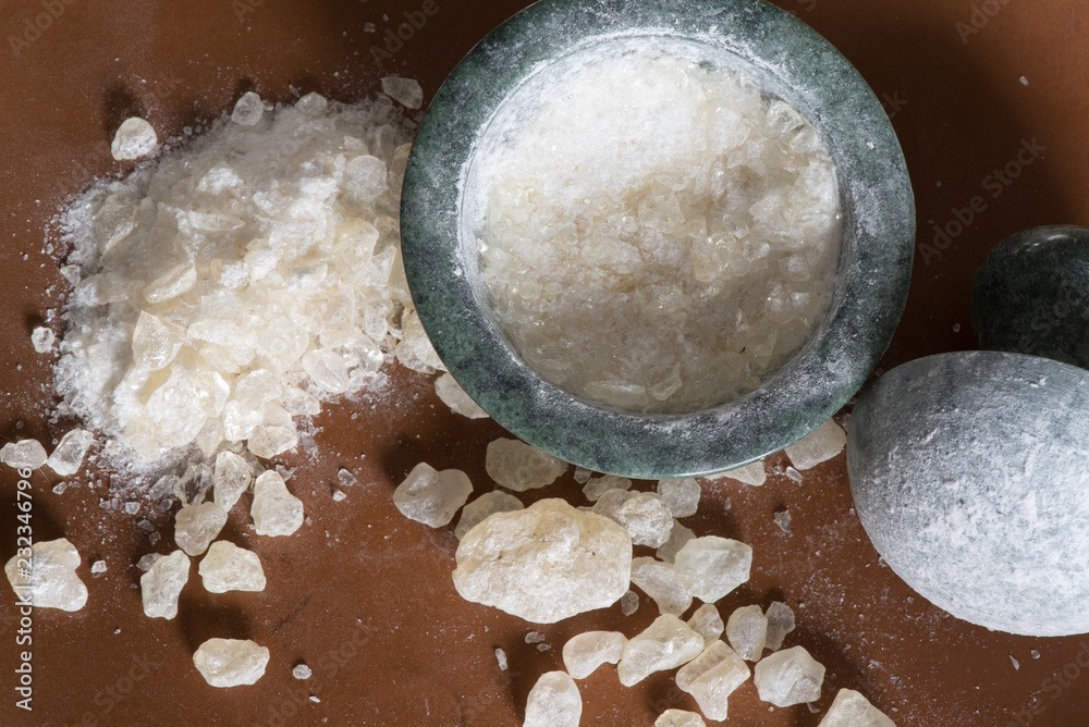 Damar Resin crystals being crushed with a green marble mortar and ...