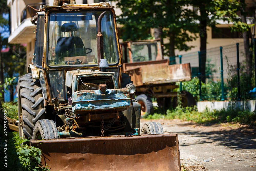 Old rusty abandoned tractor on the street of Georgia. Authenticity of ...