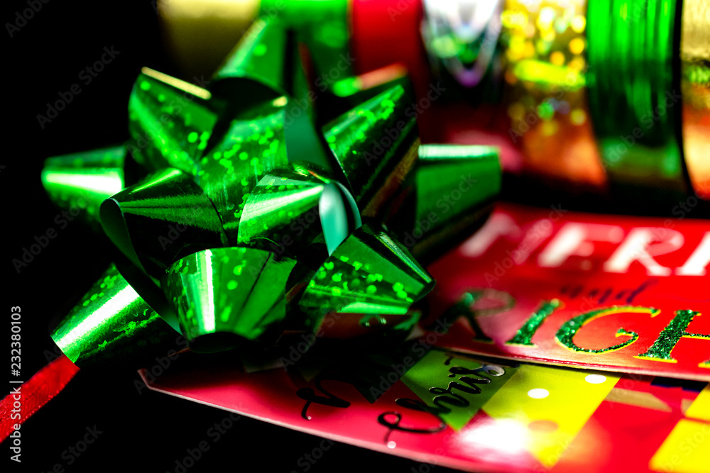 Holographic green christmas bow with two gift tags and ribbon roll in ...