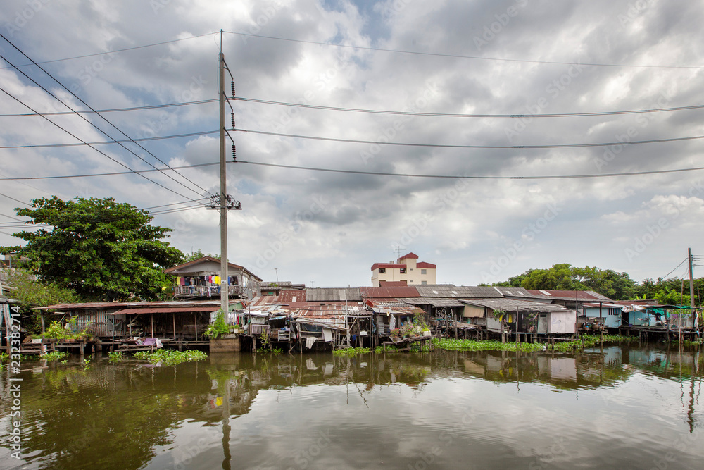 Stilt houses at a klong in Bangkok. Klongs are the canals, that branch ...