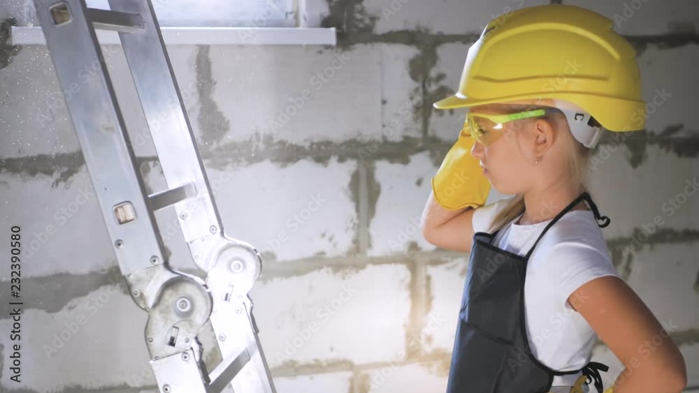 Beautiful little girl in helmet with tools. Building, development ...