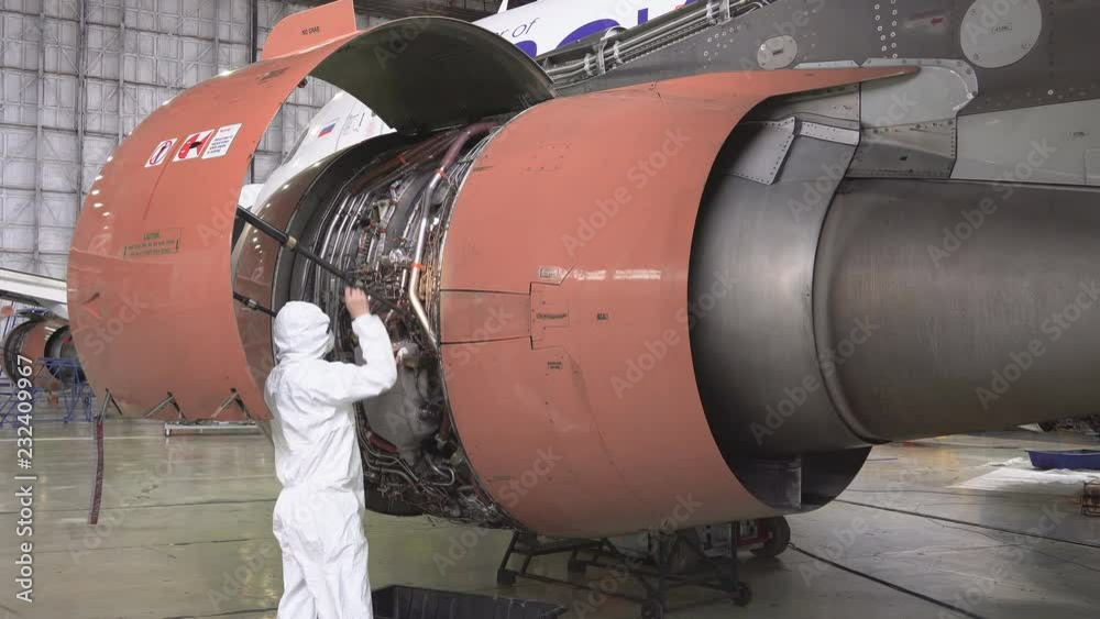 Engine passenger aircraft maintenance. Engineer checks the engine of ...