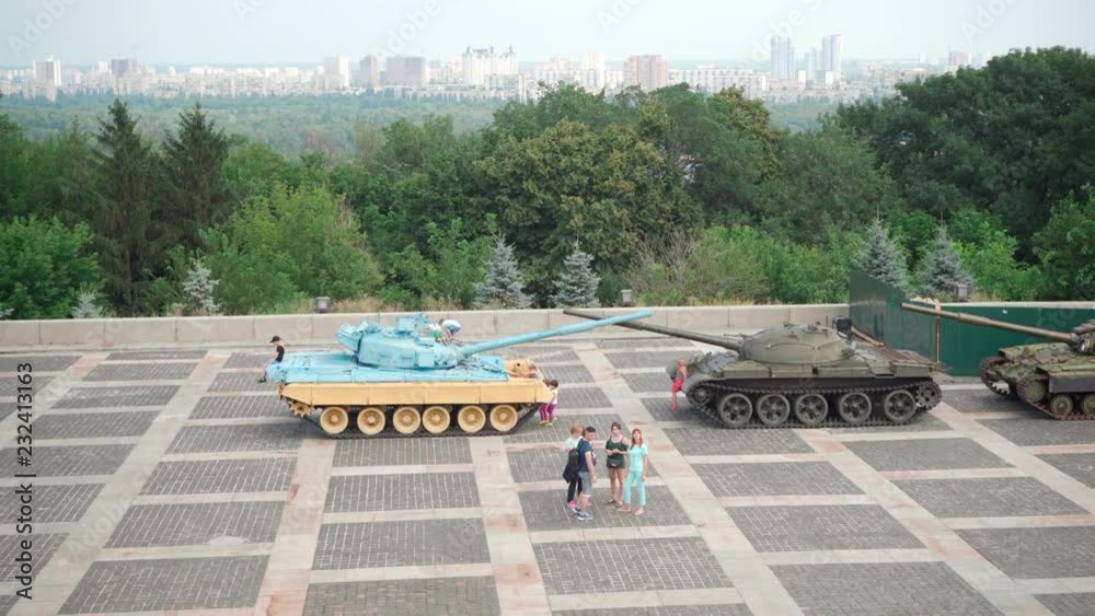 Children playing on tanks in war museum in Kiev, Ukraine. Symbol of war ...