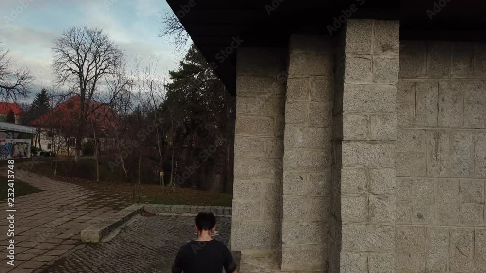 Fast Paced Aerial Drone Shot of a Millennial Young Adult Male Parkour ...