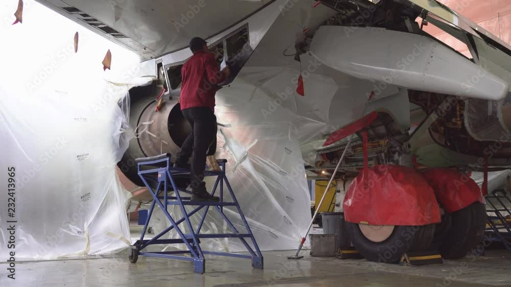 The engineer repairing the aircraft at the factory. Repair of an ...