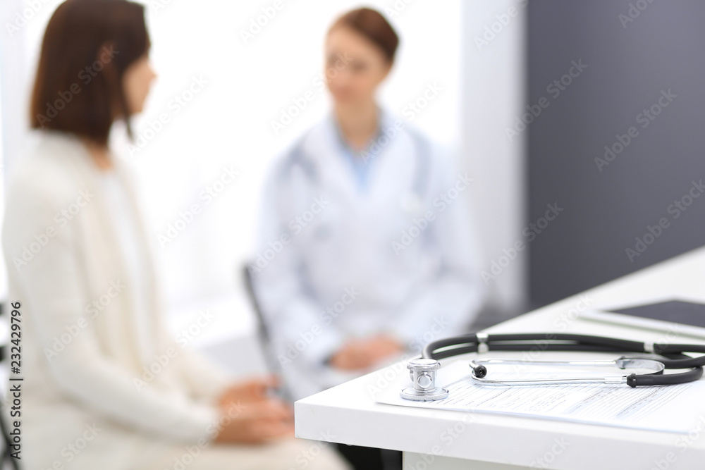 Stethoscope, clipboard with medical form lying on hospital reception ...