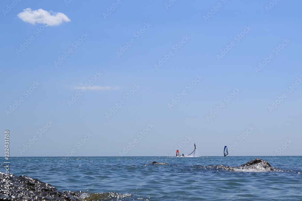 Walk on the sea on a board with a sail. Flying on a water jet. Stock ...
