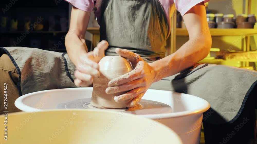 Traditional pottery making, man teacher shows the basics of pottery in ...