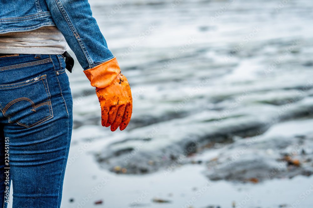 Volunteers wear jeans and long sleeved shirts and wear orange rubber ...