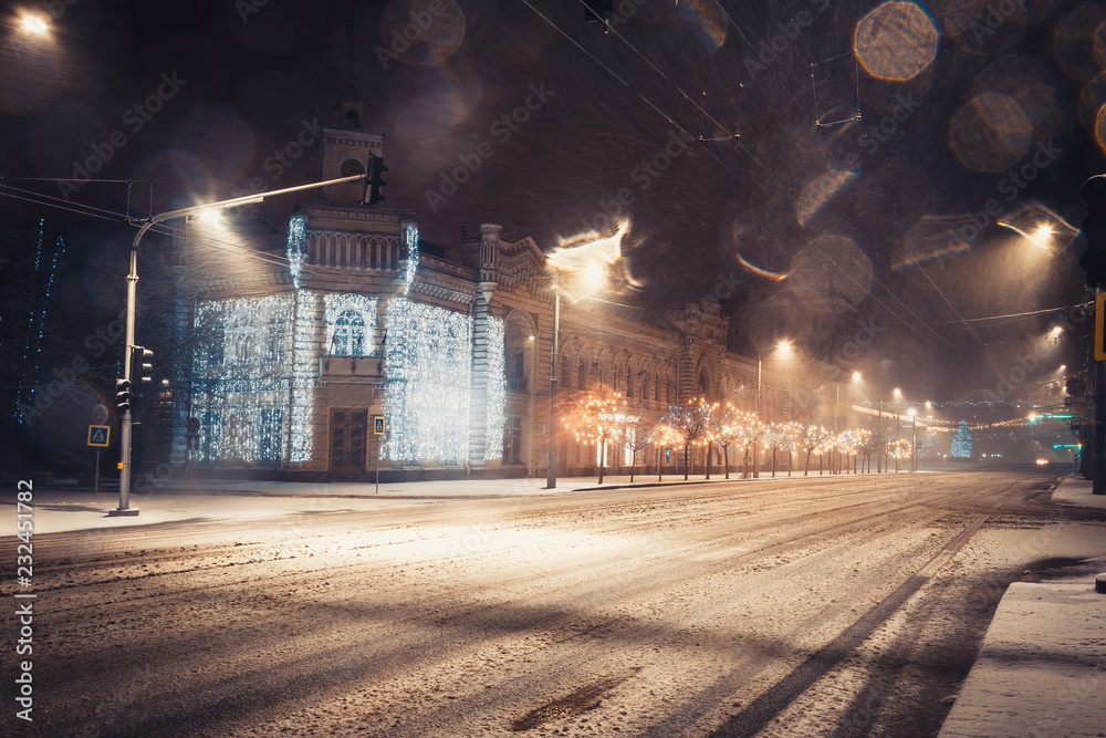 snow-covered and decorated streets of the city in the winter Stock ...