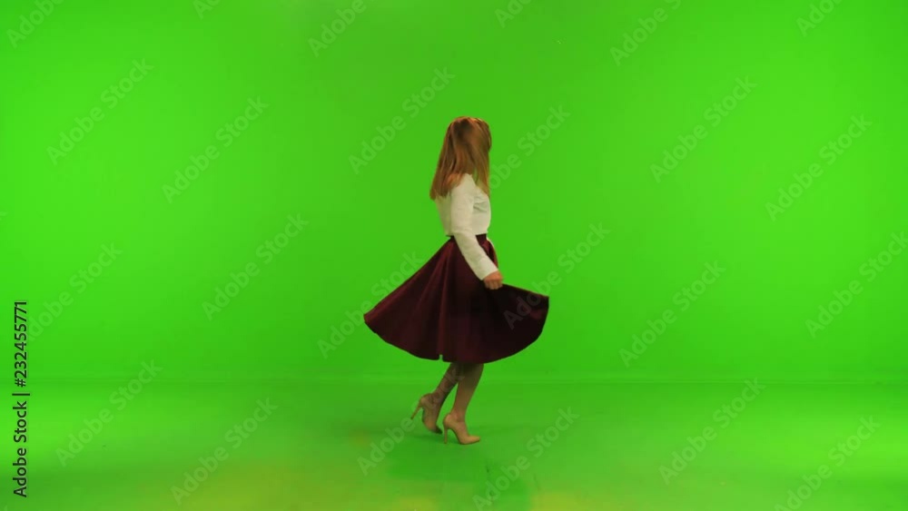 A blonde actress poses for the camera, spins and smiles, trying out her ...