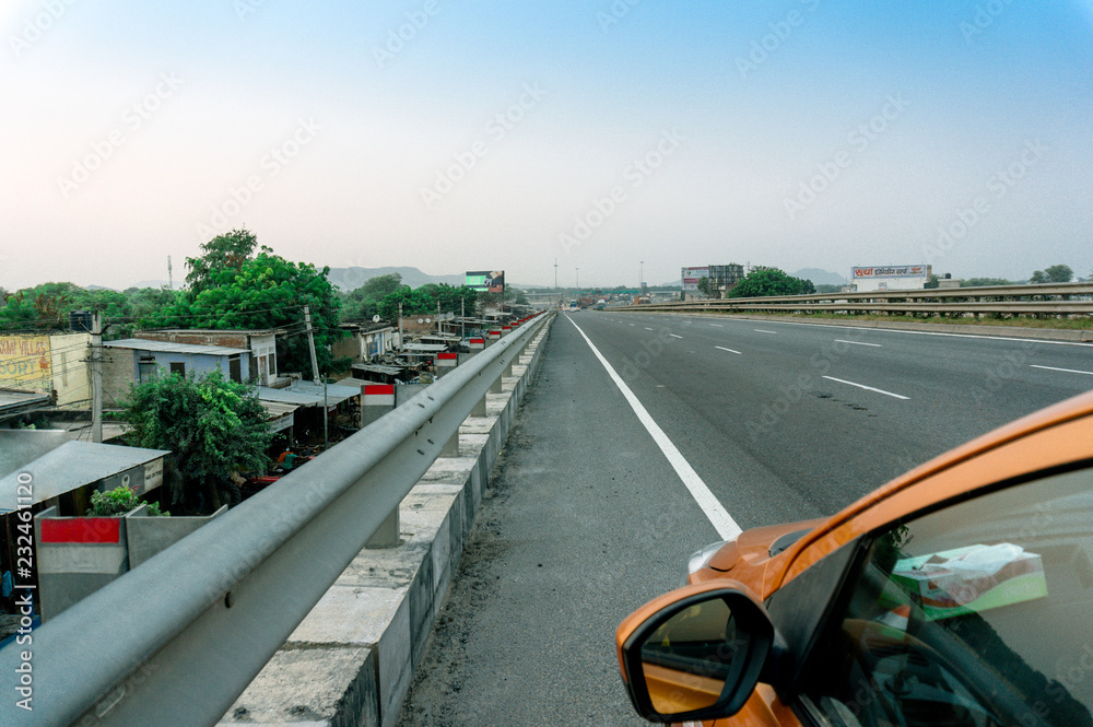Car facing off into the distance with a long highway. The beautiful ...