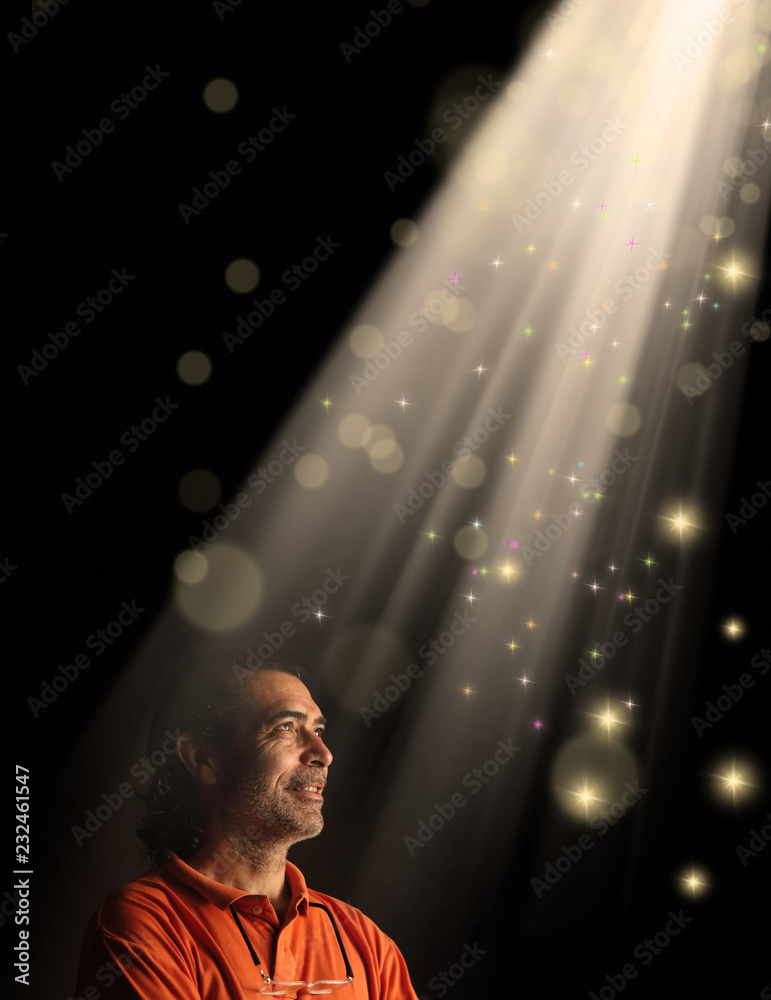 Conceptual portrait of adult man with beam of light and abstract light ...