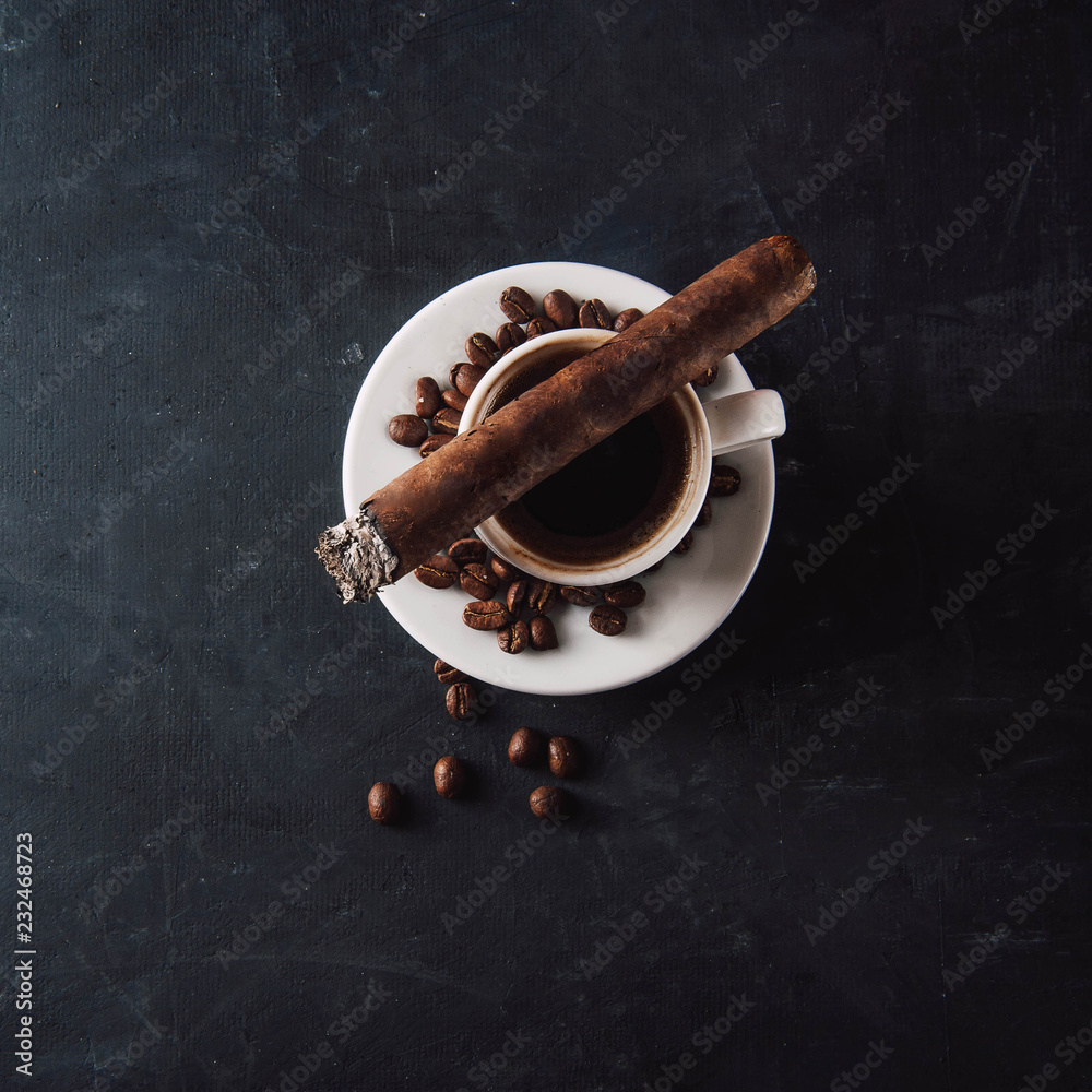 Cup of coffee, coffee beans, ashtray with cigar on dark background ...