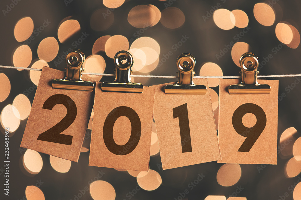 2019 new year sign pegged to a string with blurred bokeh lights in the ...
