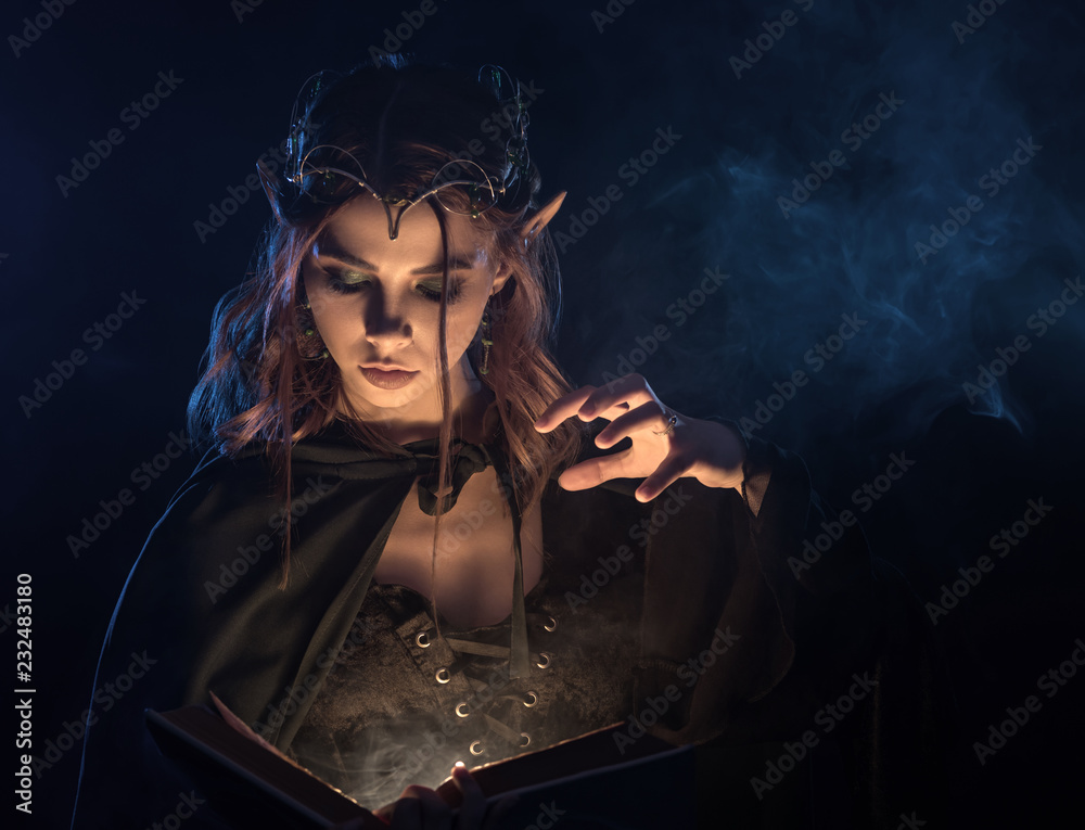 Charming girl in emerald cloak practising magical skill. Stock Photo ...