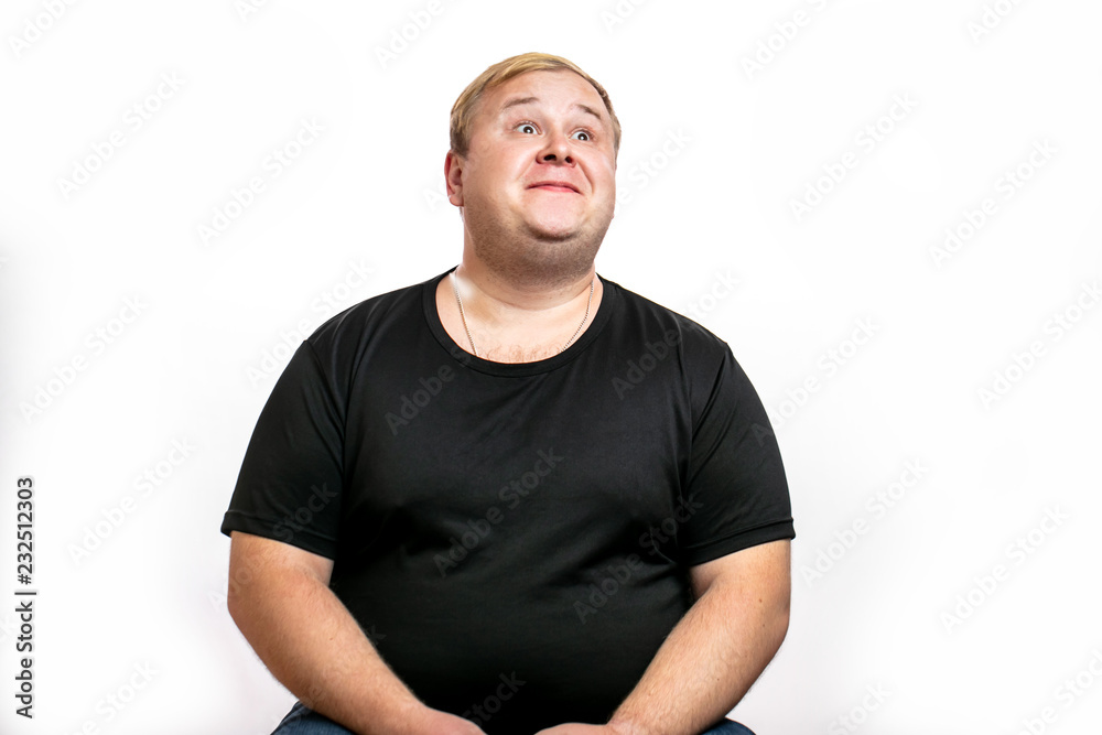 Excited kind-hearted chubby overweight man feeling happy looking up at ...