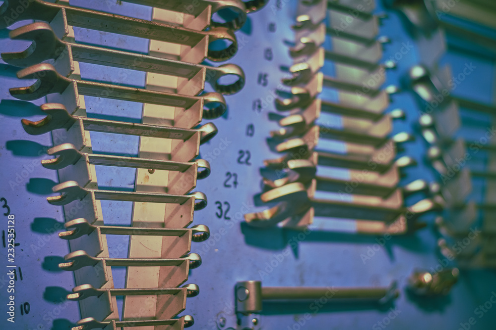 Blue board in ship's engine workshop with plent different types of ...